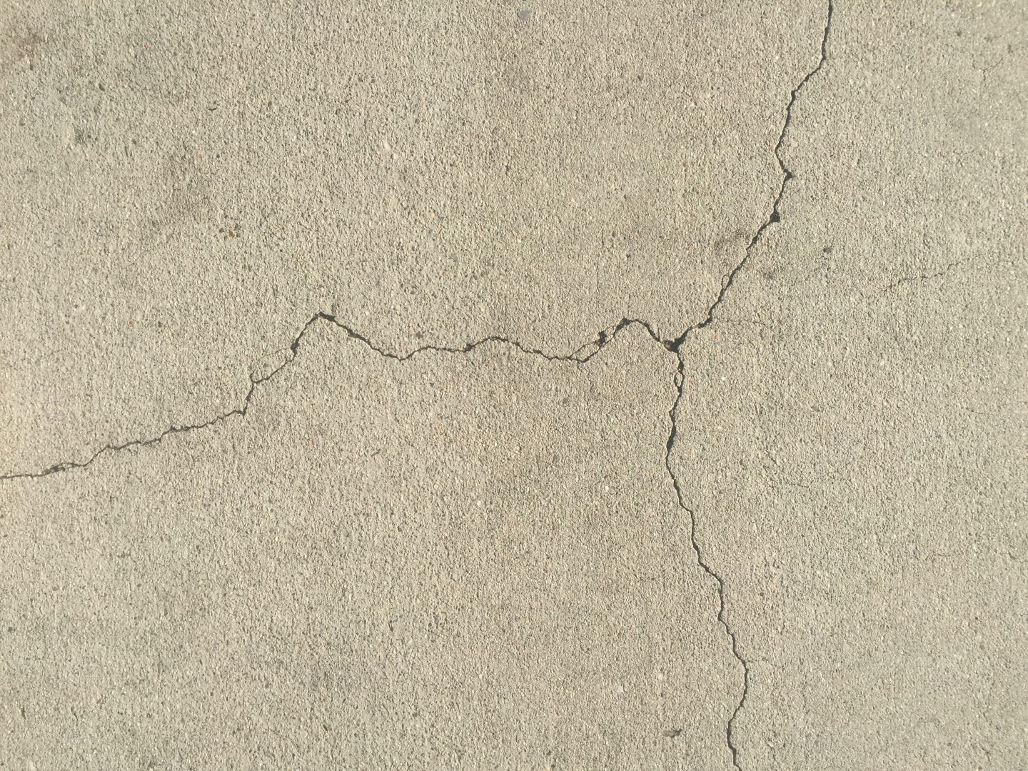 Lightly textured clean concrete with fractured crack | Free Textures