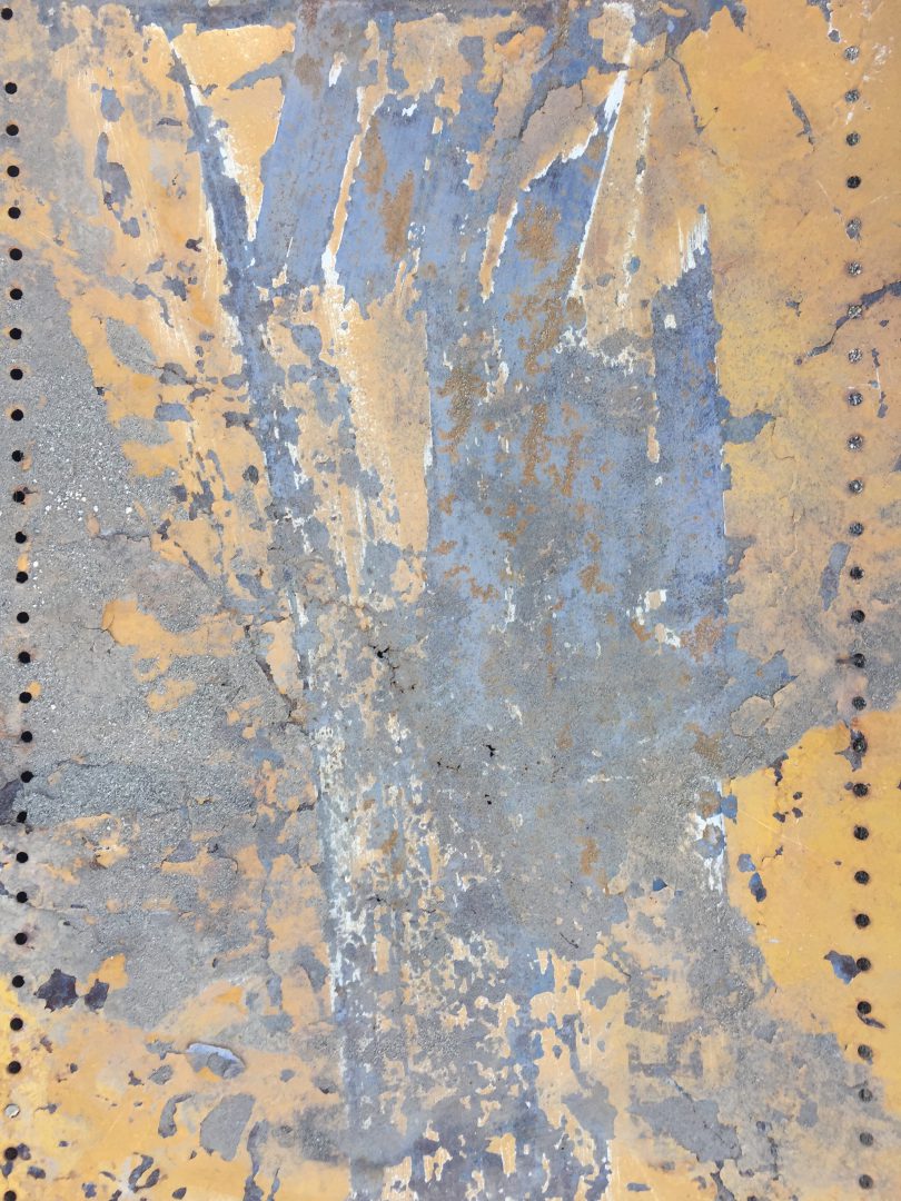 Dented metal with layers of flaking mustard yellow paint | Free Textures